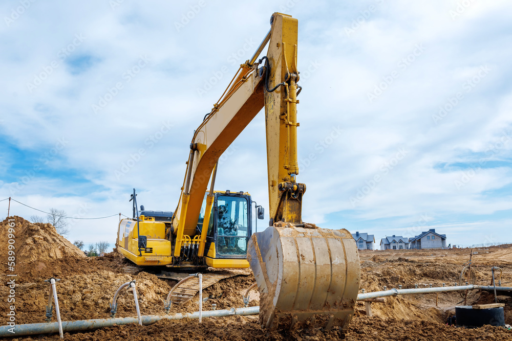 Excavator dig the trenches at a construction site. Trench for laying ...