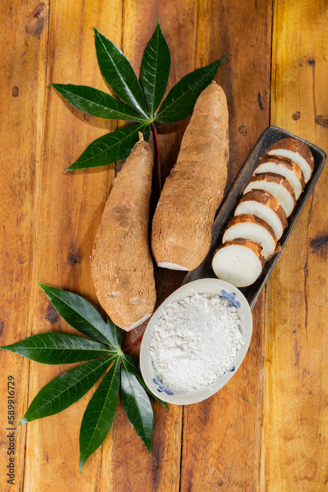 pile of cassava, cassava and cassava flour on a background of rustic ...