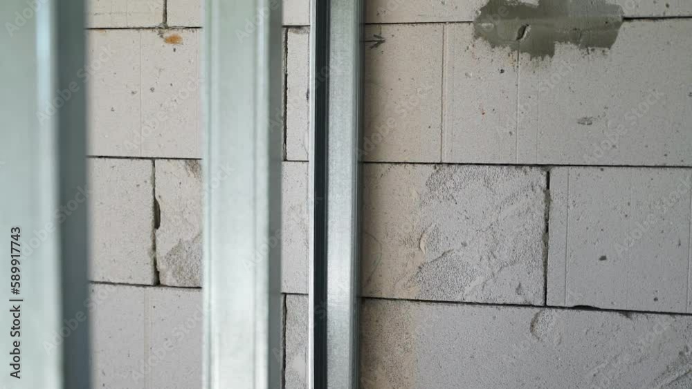 Fastening galvanized U profile to a wall of aerated concrete bricks ...