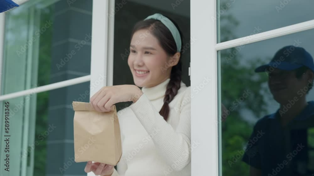 Happy smiling Asian woman receives paper bag parcel of food from ...