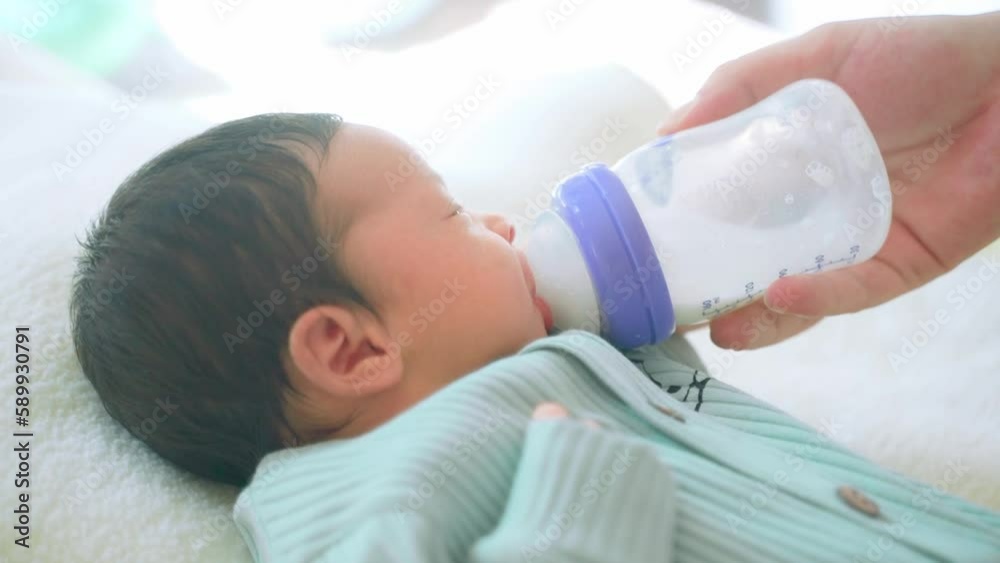 Loving mother feeding her little girl child with breast milk baby ...