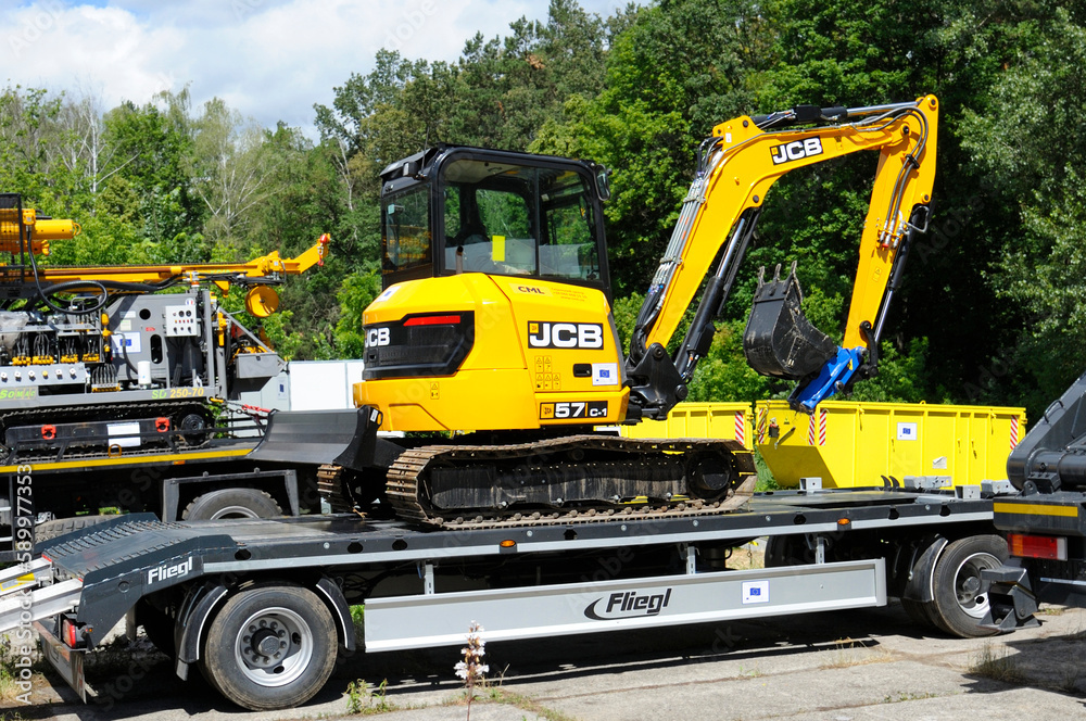 Backhoe JCB loaded on a truck platform for transportation Stock Photo ...