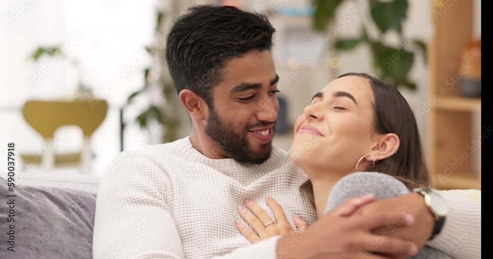 Love, hugging and couple on a sofa, bonding and spending quality time ...