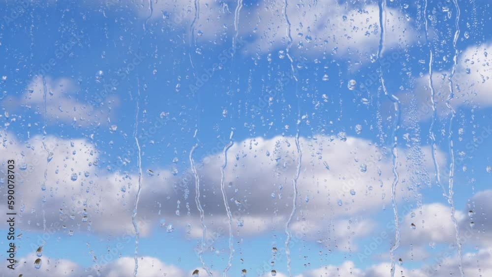 Rain Drops Flow Down Glass Against a Background of Moving Clouds and ...