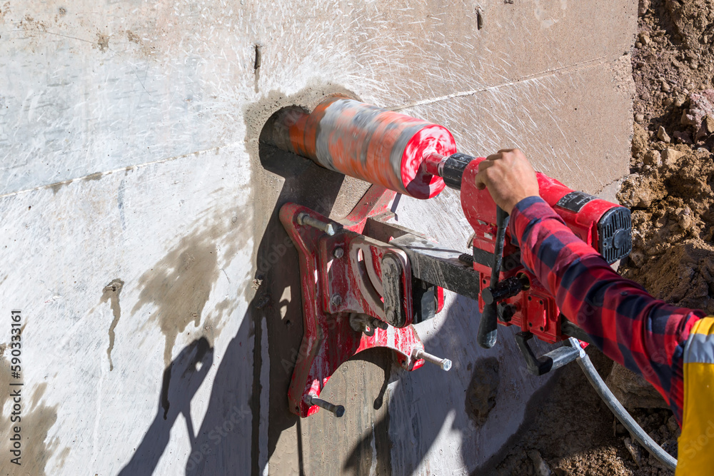 Zdjęcie Stock: Worker is drilling to concrete wall with core drill ...