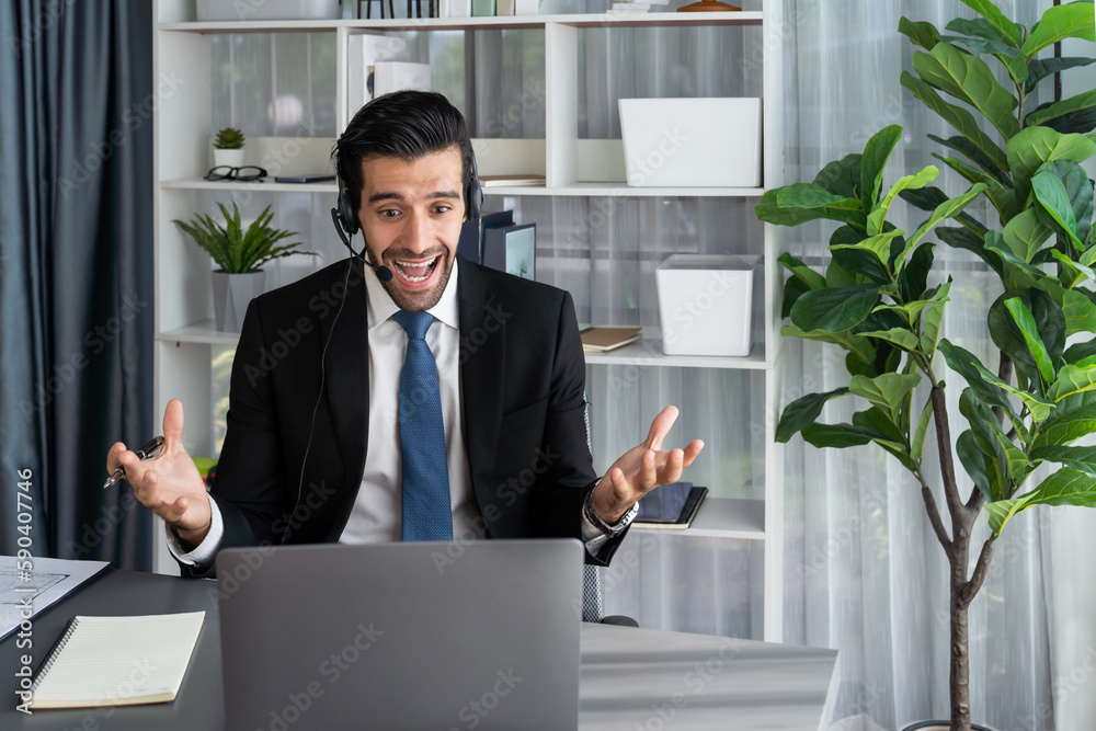 Male call center operator or telesales representative siting at his ...