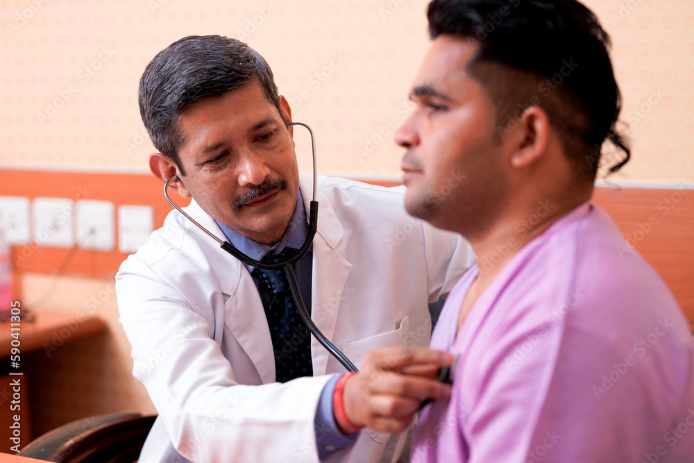 Doctor checking to patient with stethoscope at clinic. Stock Photo ...