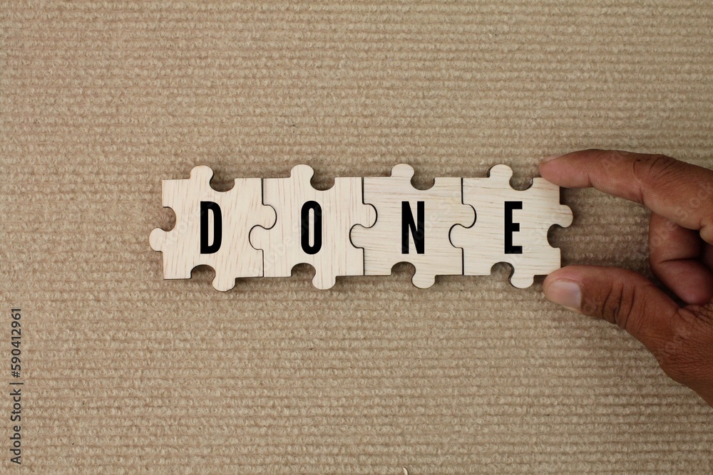 wooden puzzle with the word done. concept is complete. task completion ...