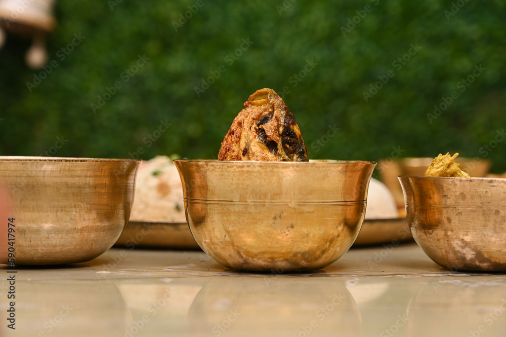 Catla (Katla) fish head curry in a bowl at restaurant or home. Macher ...
