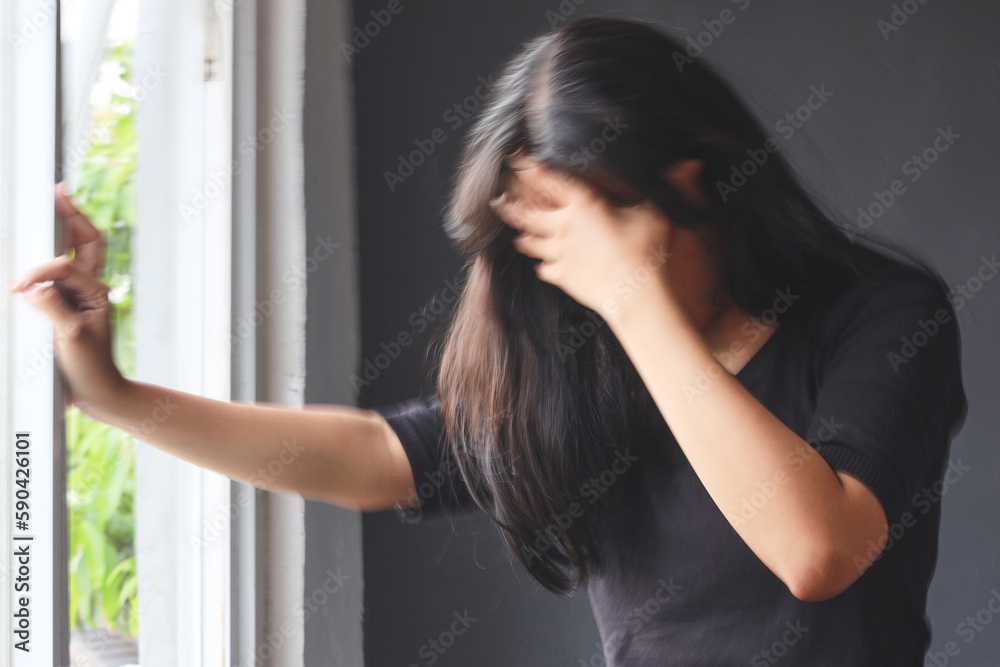 Tired young woman touching forehead having headache migraine or ...