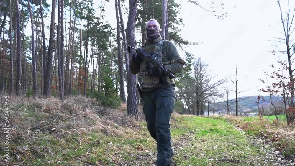 Soldier during a military operation, fully equipped camouflage on a ...