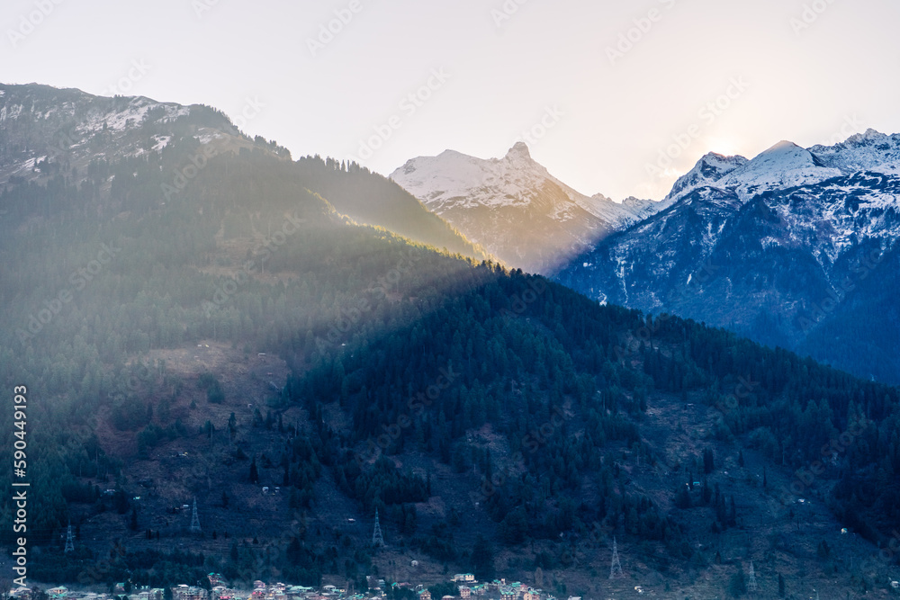 Light rays from sunrise behind himalaya mountains flooding light over ...