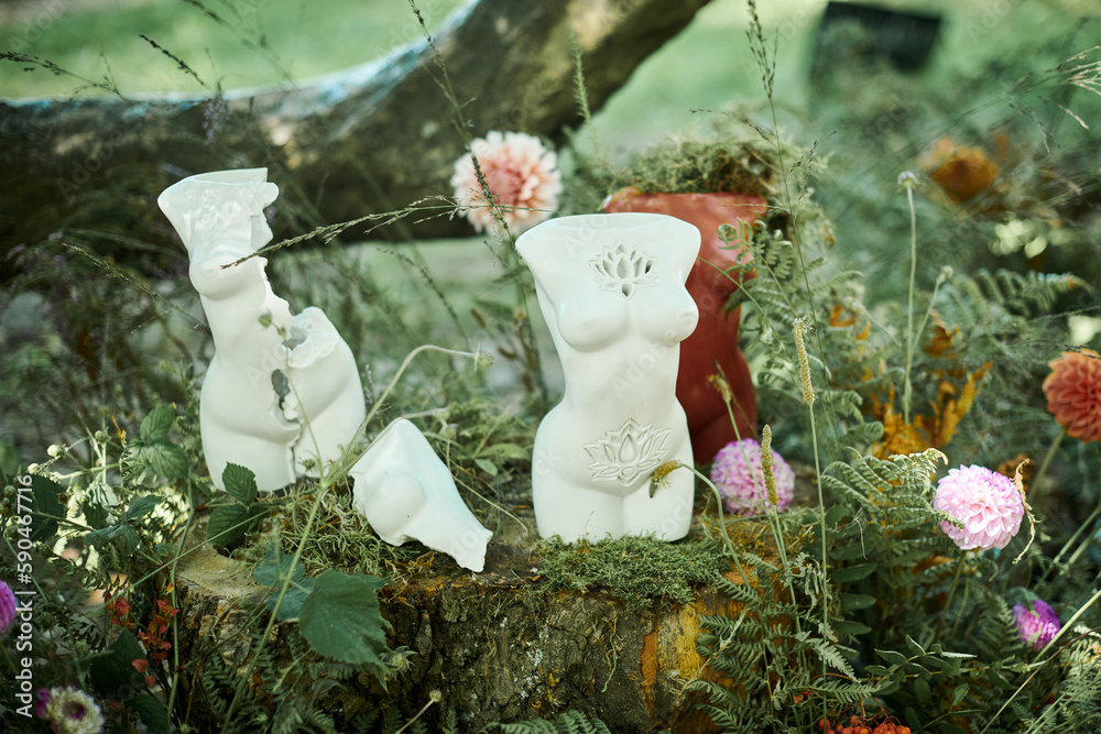 Female statues art objects on outdoor green forest background, beauty ...