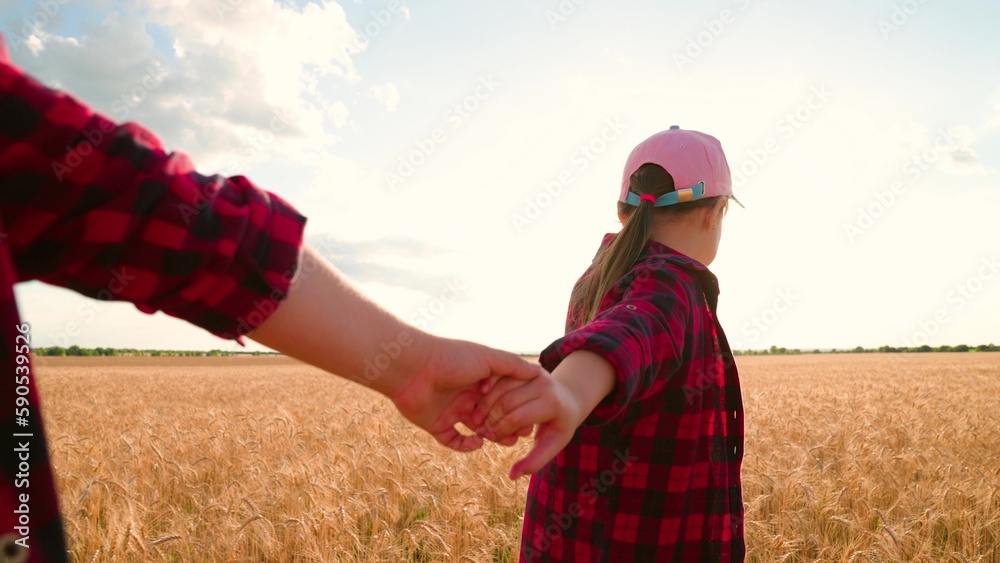 Little girl and boy run hand in hand across field. Concept of childrens ...