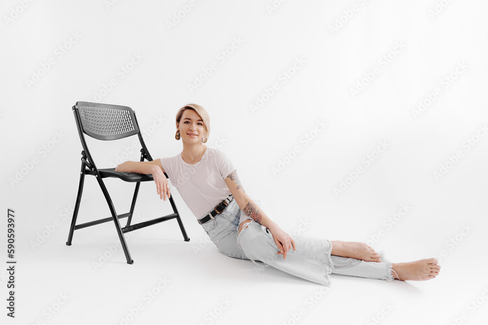 Side view of thoughtful female lying with crossed legs on floor and ...