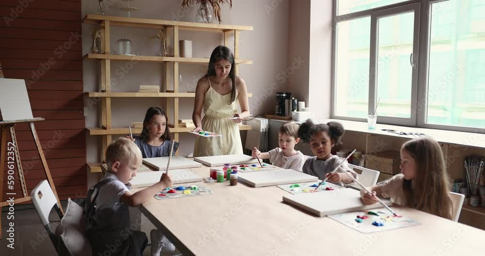 Group of art school students kids drawing in acrylic paints on canvas ...