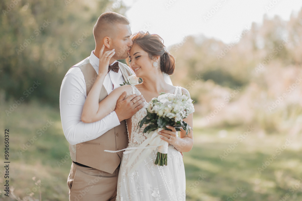 Wedding photo in nature. The bride and groom are standing in the forest ...