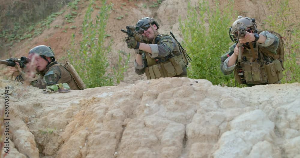 confident group of soldiers holding kneeling position aiming machine ...