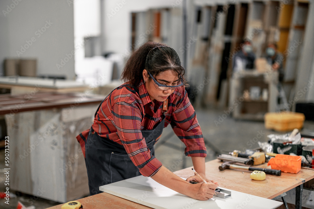 A Carpenter carefully measures, marks dimensions, and lays out ...