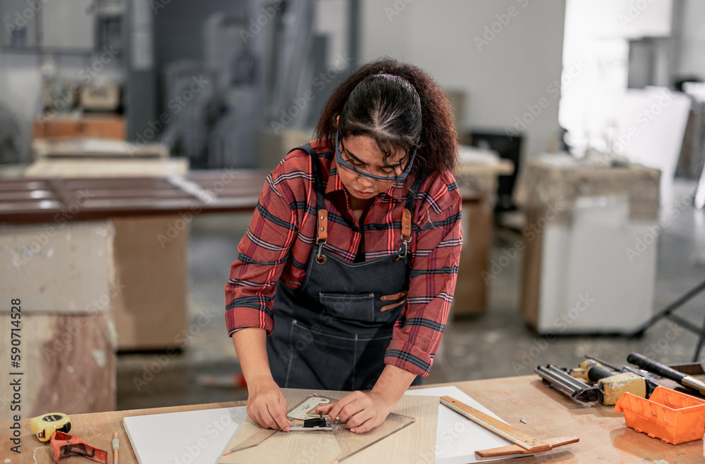 A Carpenter carefully measures, marks dimensions, and lays out ...