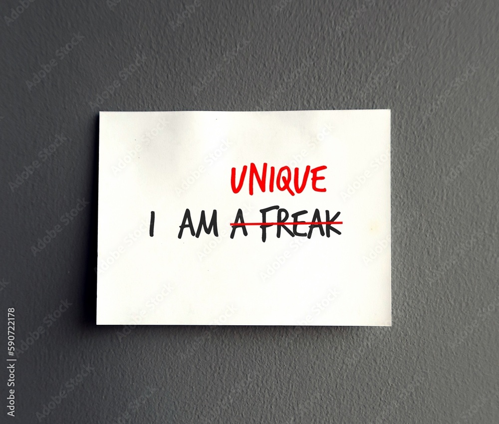 Note paper on gray wall background with handwritten text I AM A FREAK ...