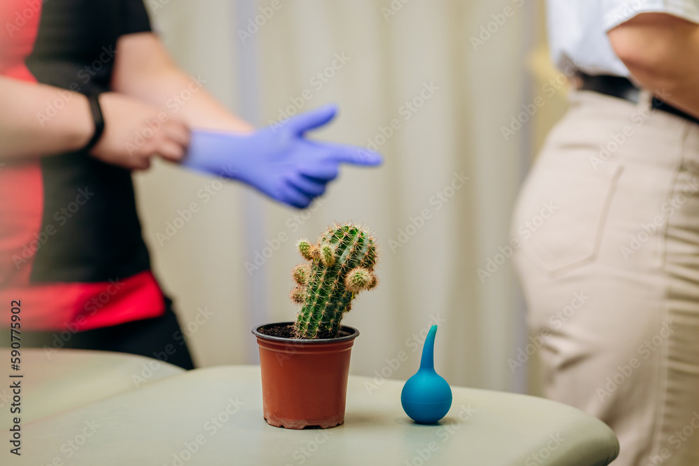 Doctor proctologist puts on medical gloves for a digital examination of ...
