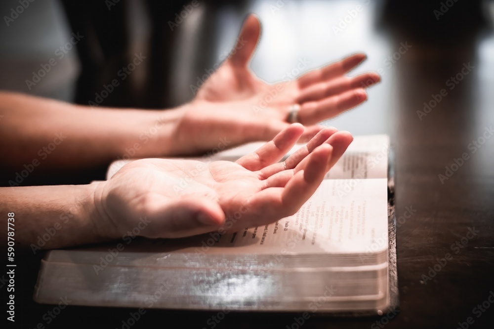 hands open in praise or worship of God with open Bible and praying ...