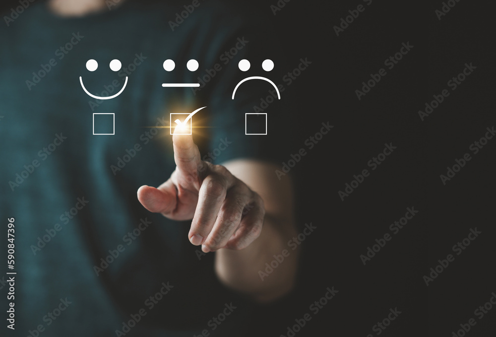 Businessman pressed the smile face emoticon on the virtual touch screen ...