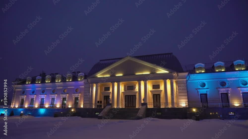 Old historical European building. The facade is yellow with white ...