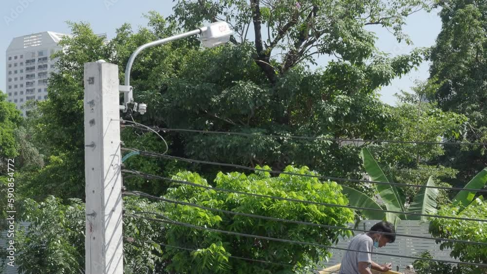 Worker on height lifting platform installing new street light bulb ...