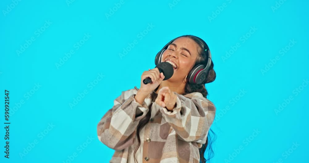 Headphones, microphone and woman singing isolated on blue background ...