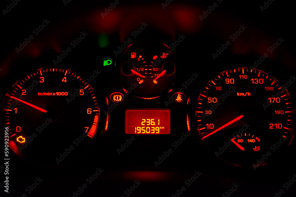 Car cockpit control panel showing full automotive meters. Illuminated ...