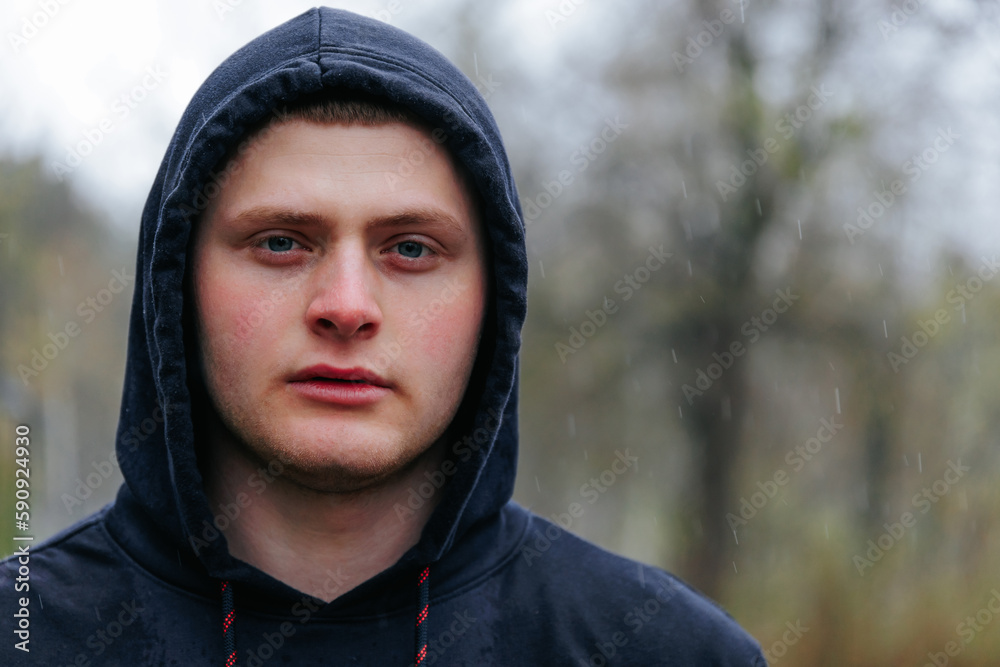 Portrait of a Young Adult Male with a Striking Gaze in Rainy Weather. A ...