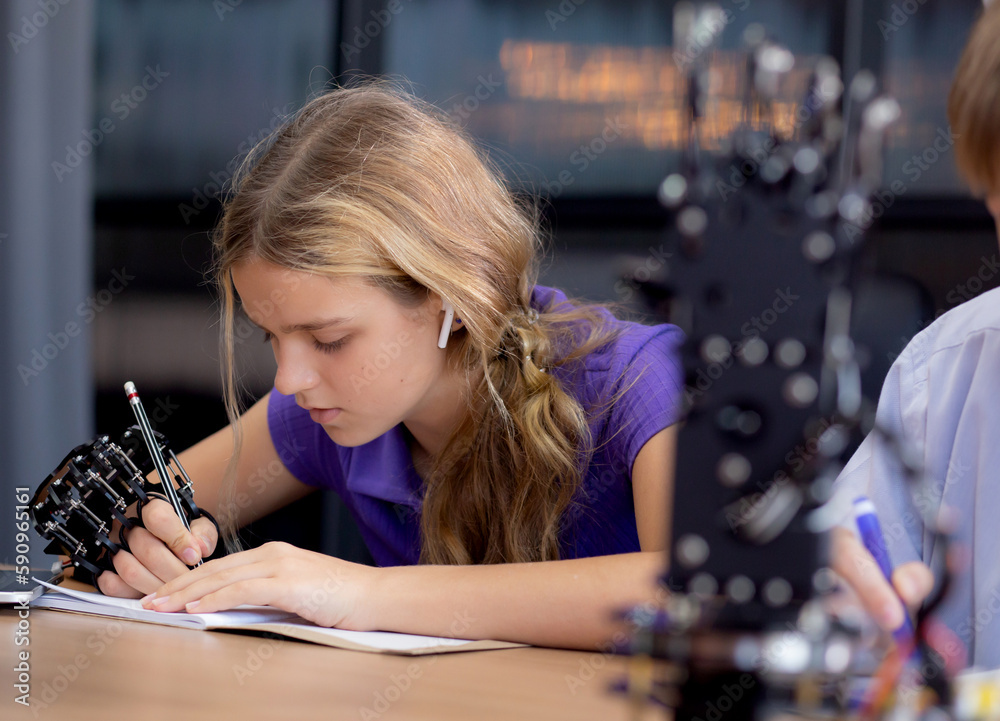 Caucasian Two Teenager Students Learning Robotic Arm In Classroom