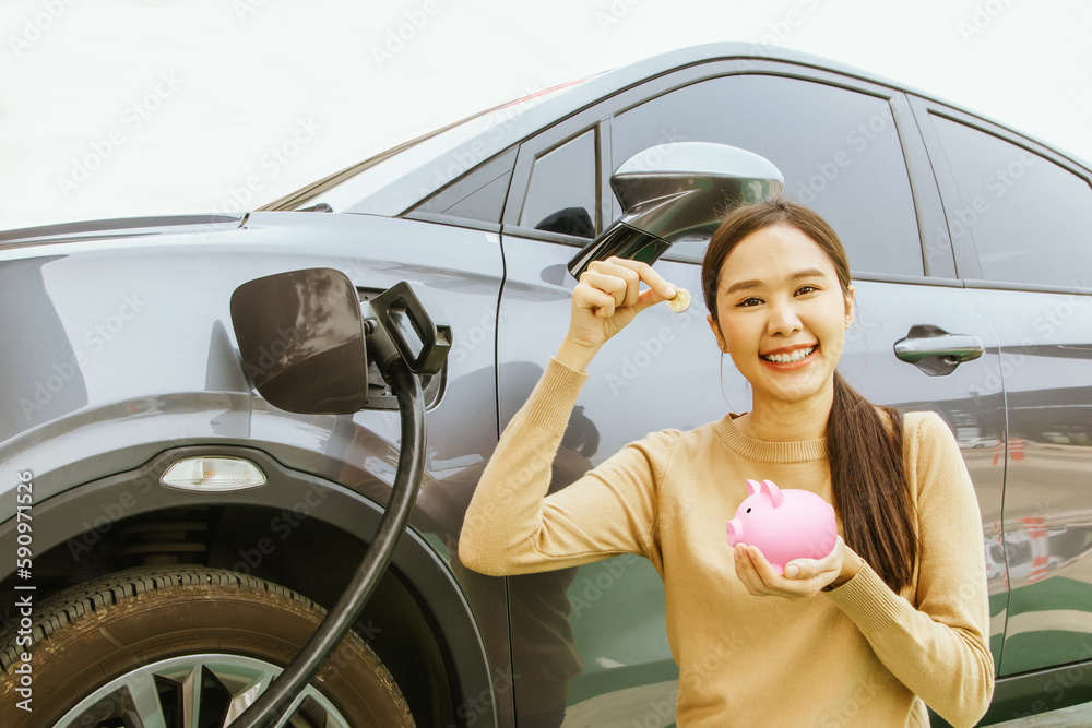 Fotka „Portrait young asian woman driving an EV electric car In the ...