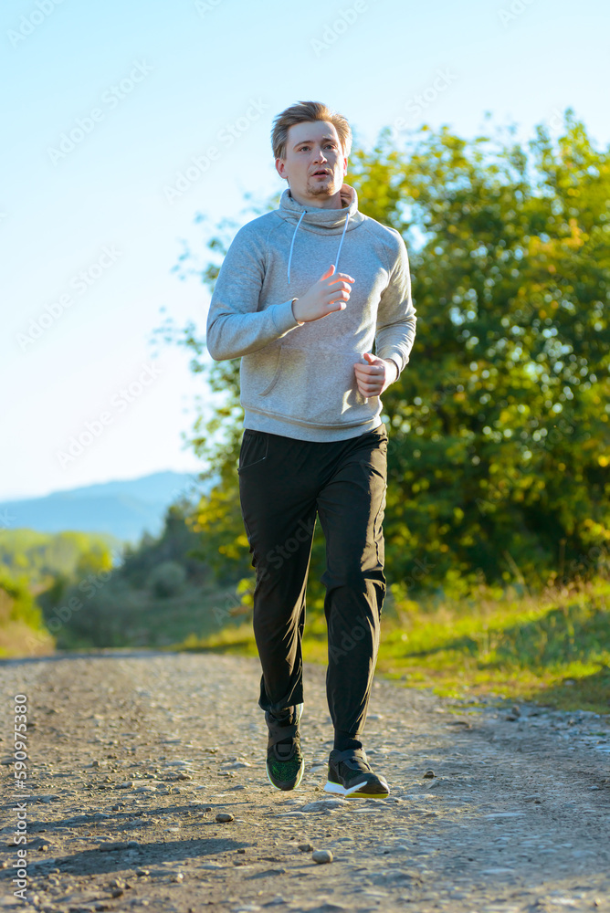 Running man jogging in rural nature at beautiful summer day. Sport ...