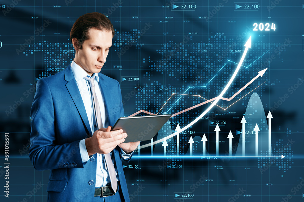 Attractive young businessman using tablet with growing business chart ...