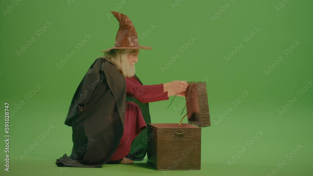 Green Screen.An Old Wizard in a Medieval Clothing and in the Magic Hat ...