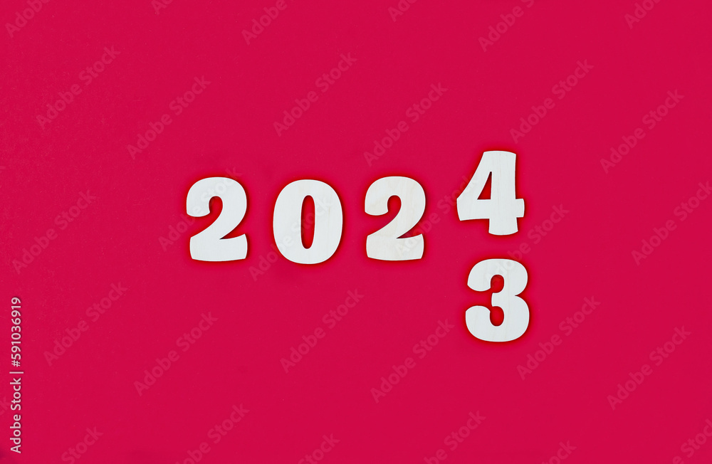 From 2023 to 2024 wooden numbers on a red background. Mid-year concept ...