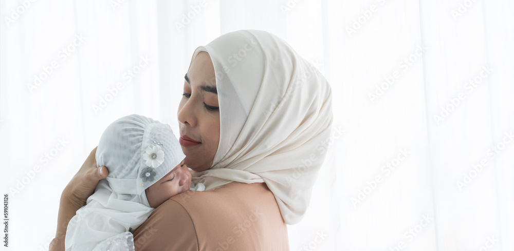 Portrait of Asian Muslim mother wear hijab holding carrying her cute ...