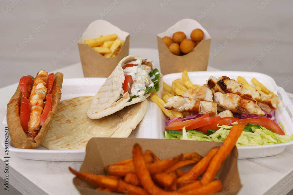 Traditional Greek fast food served on table in a cafe. Gyros sandwich ...