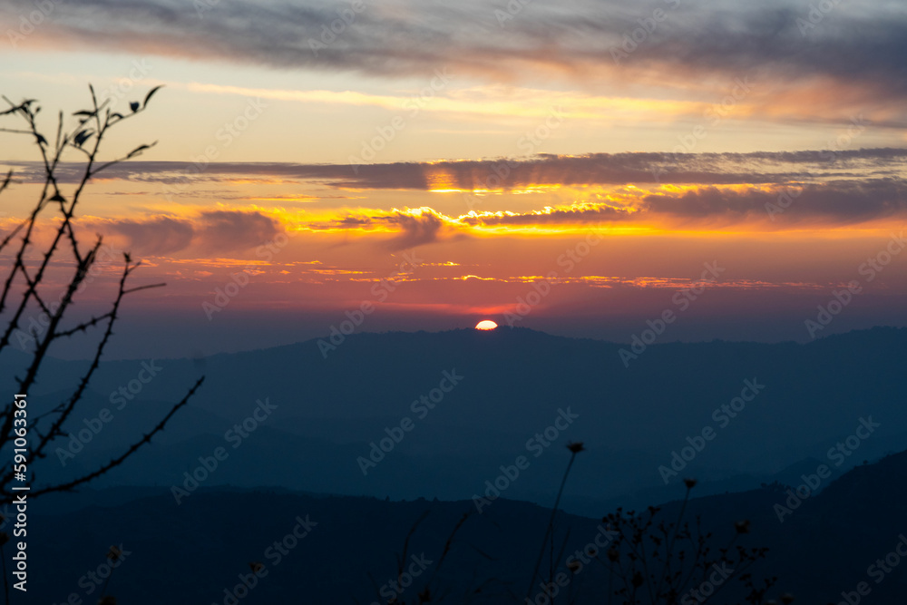 Dramatic sunset landscape with dark clouds. Sun setting behind the ...
