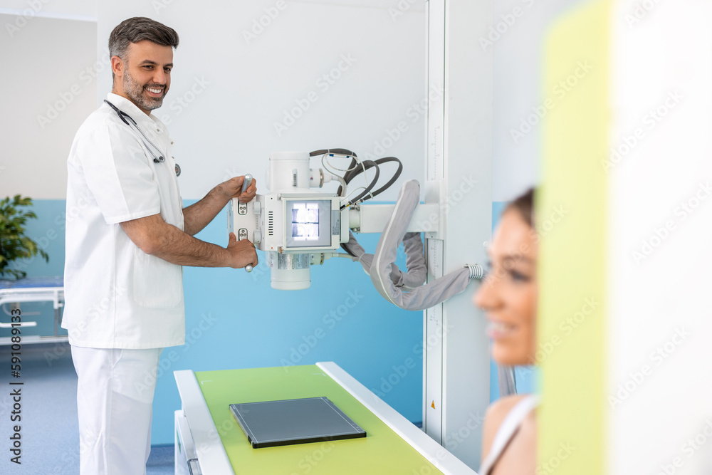 Radiologist setting up the machine to x-ray female patient. Radiologist ...