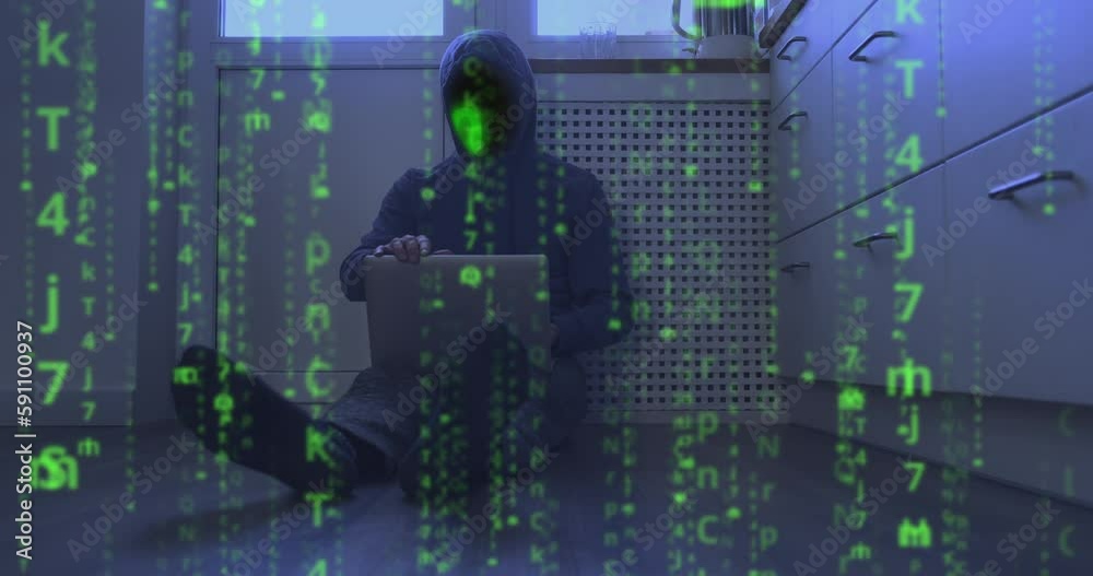 Matrix video effect, hacker in hood sitting on floor with laptop ...