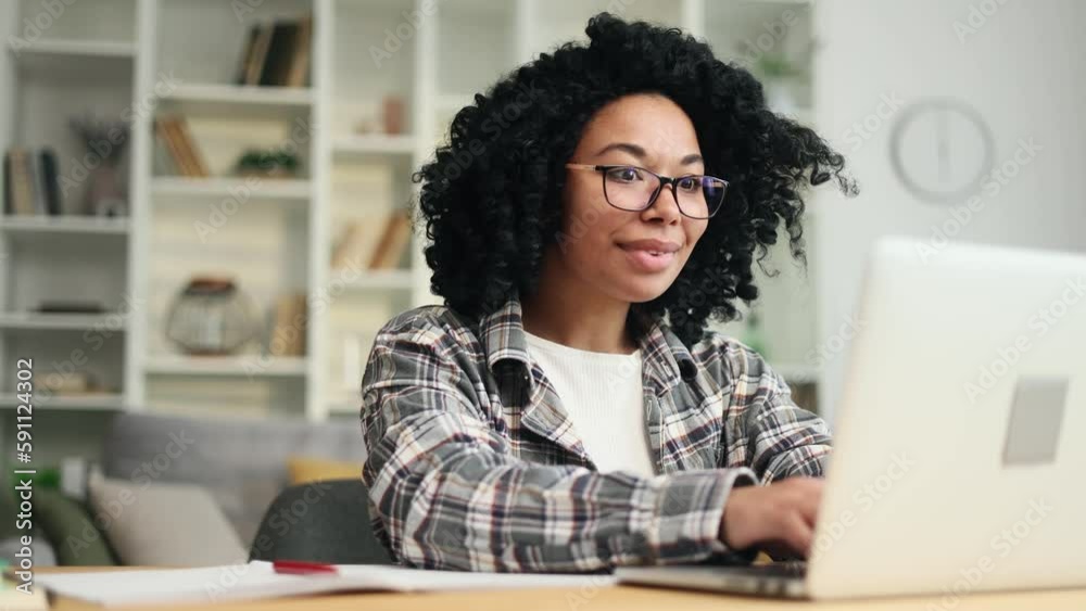 Portrait of young african american woman student looking at laptop ...