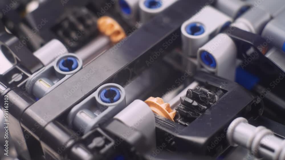 Gears and details moving rotating on toy electric vehicle chassis macro ...