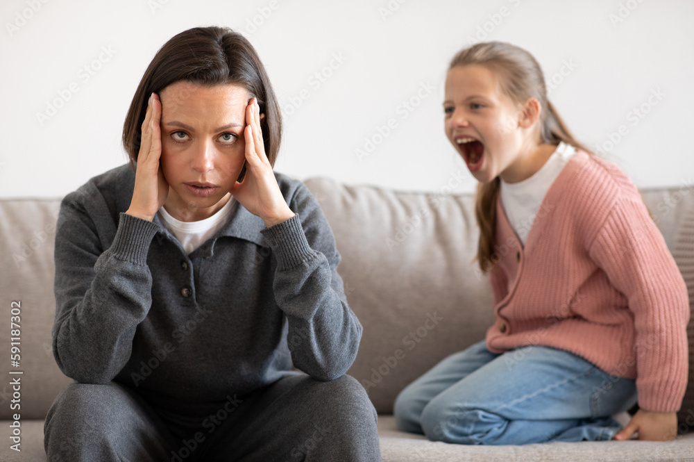 Angry excited aggressive teenager european girl yelling at sad tired ...