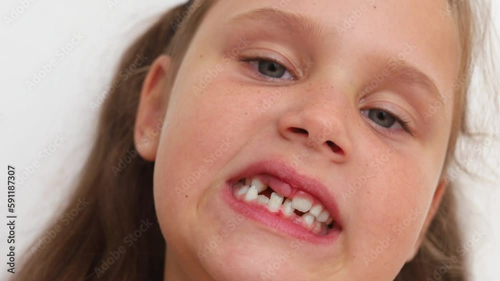 Video shot of small little blond girl with ponytails showing toothless ...