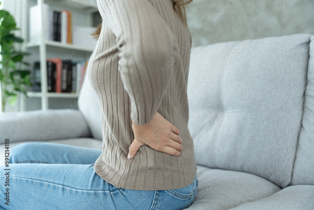Asia beautiful woman holding her lower back while and suffering from ...