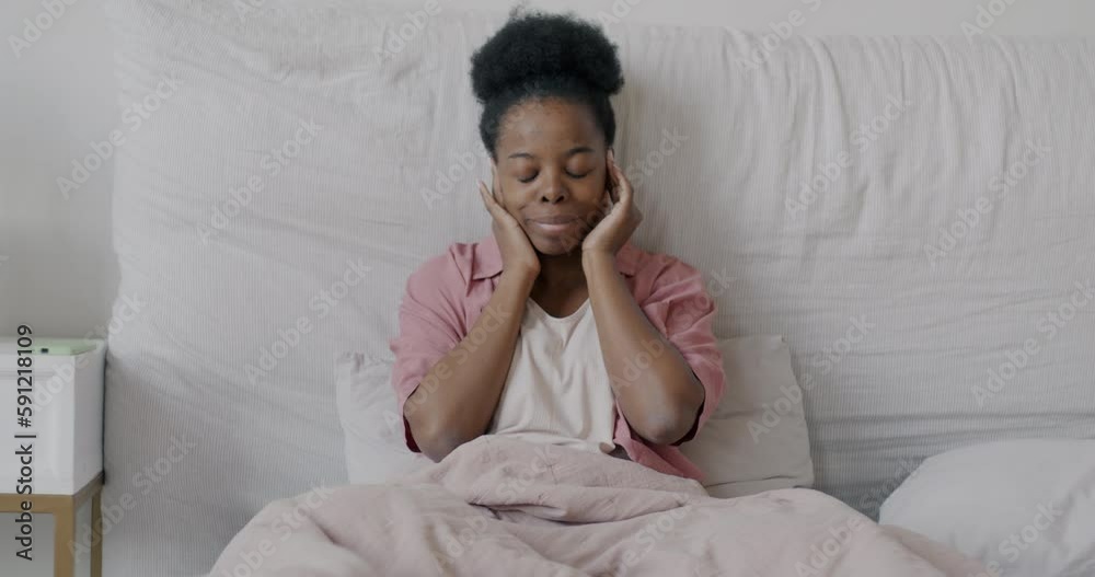 Angry young woman can't sleep because of loud noise covering ears with ...